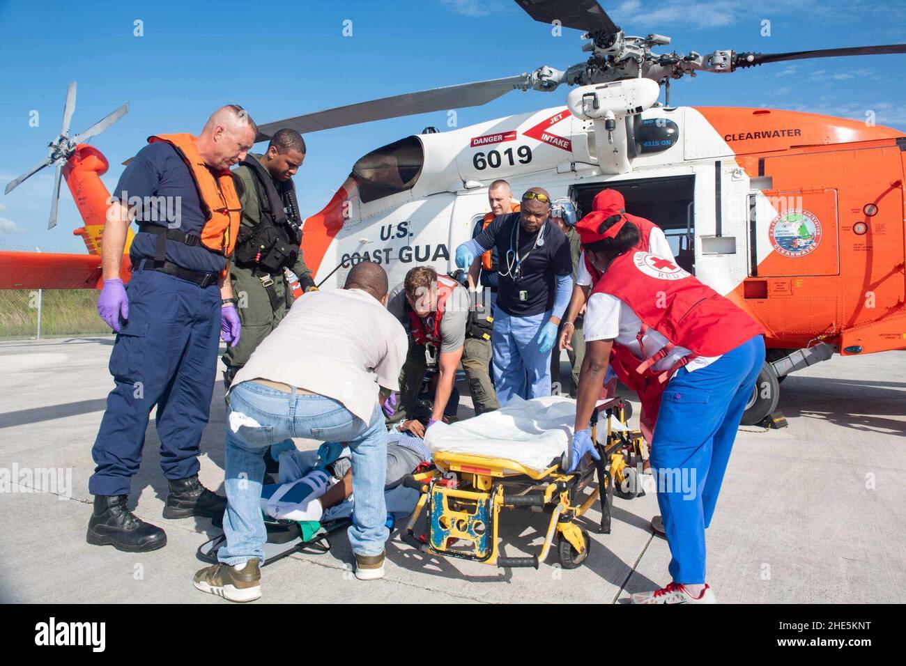 Sailors and Coast Guardsmen transport a patient in response to ...