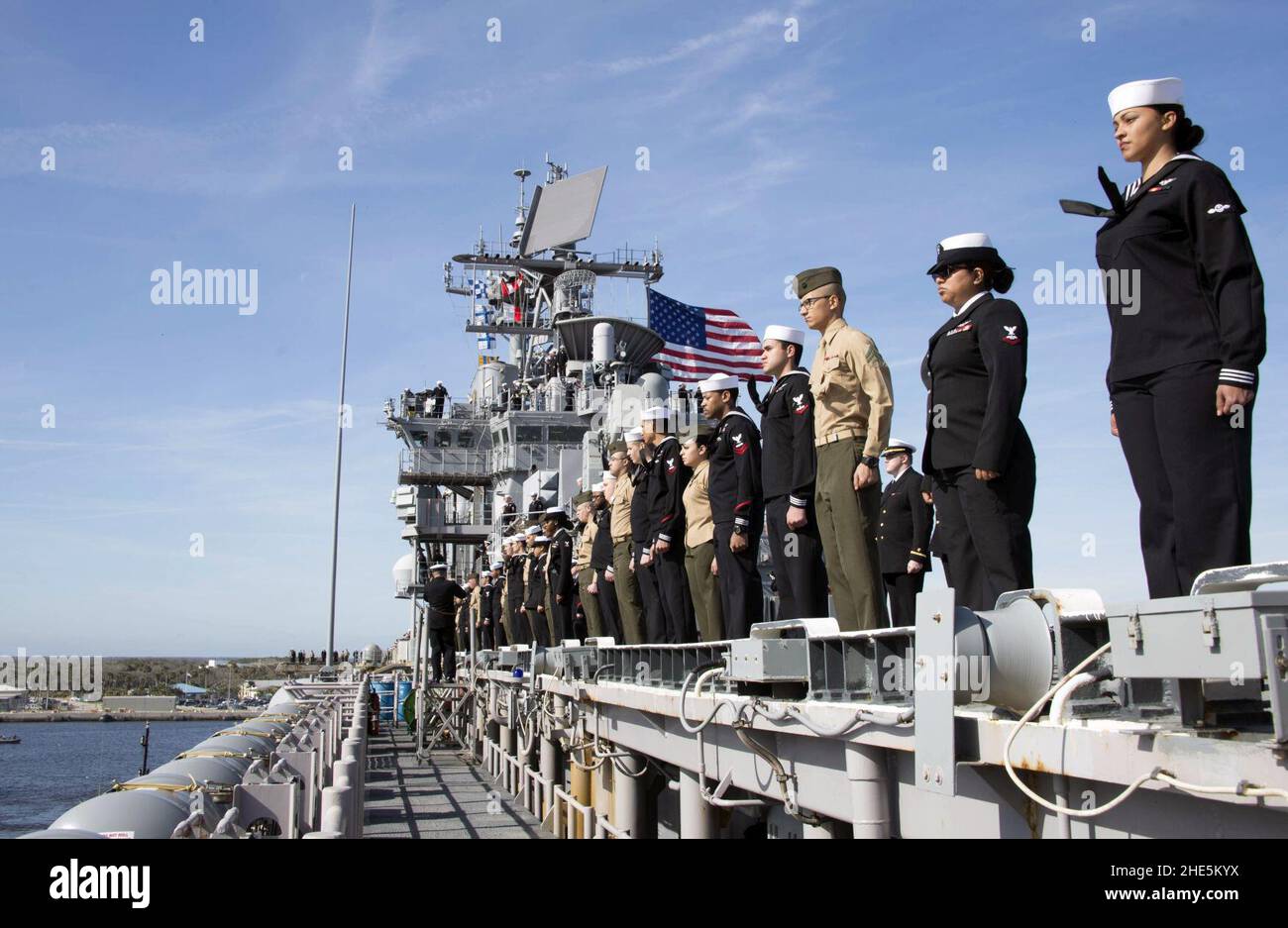 Sailors and Marines man the rails on the flight deck of USS Iwo Jima ...