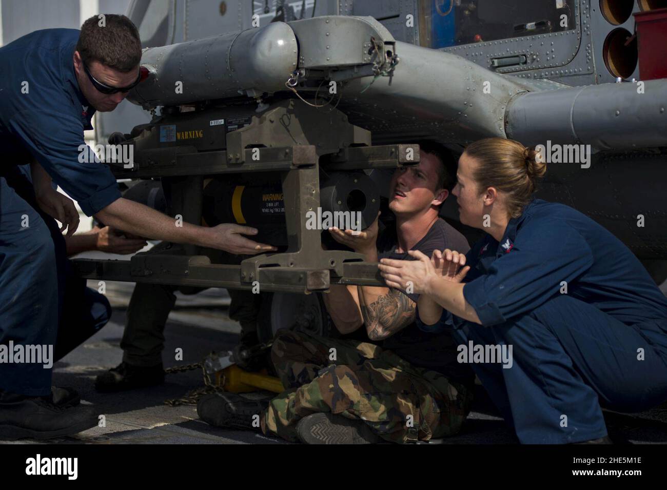 Sailors arm a Sea Hawk helicopter. (8613442724 Stock Photo - Alamy