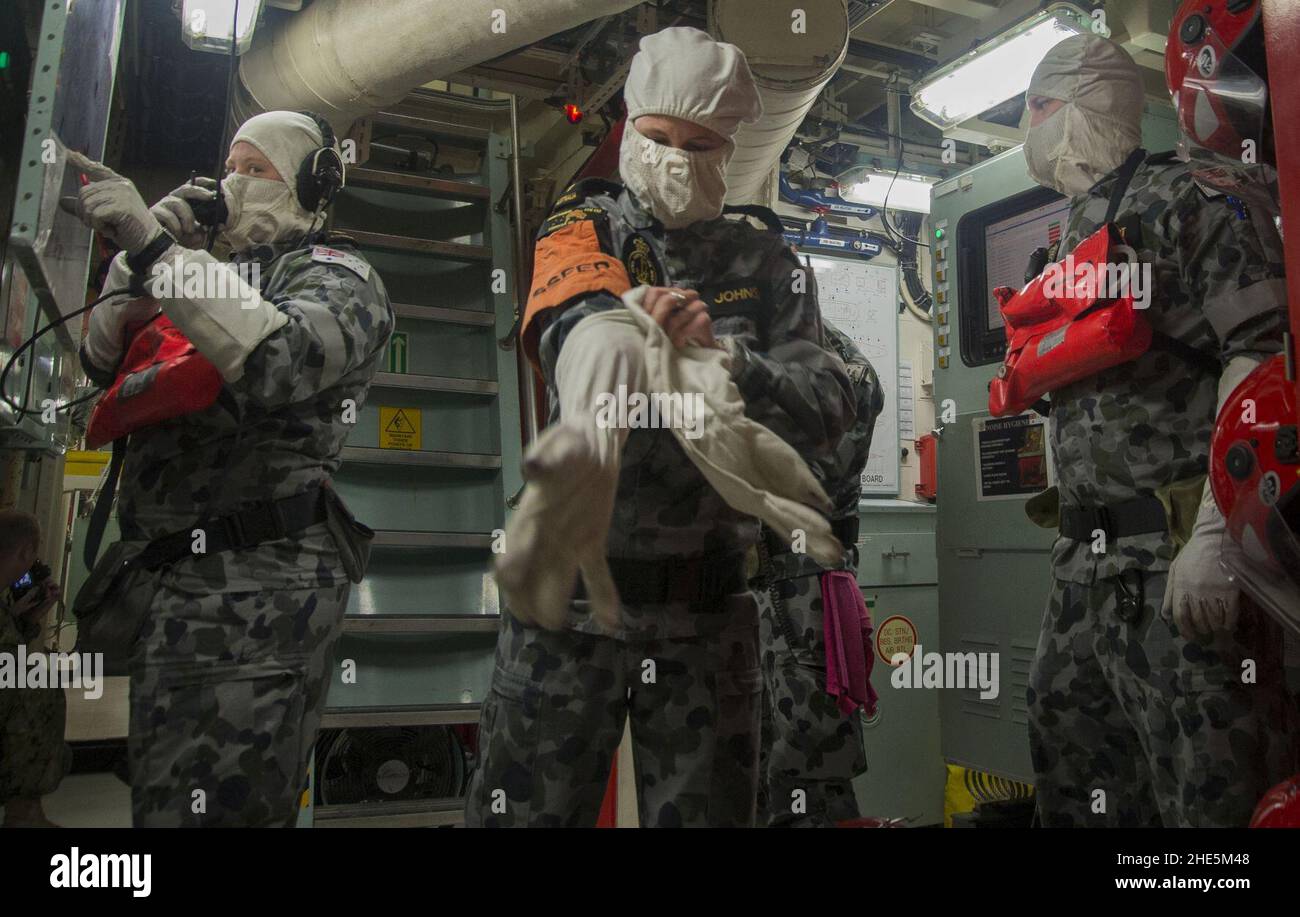 Sailors assigned to HMAS Arunta don protective gear during an exercise ...