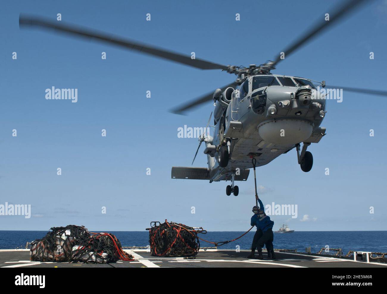 Sailors attach a cargo sling to a Royal Australian Navy S-70B Seahawk ...