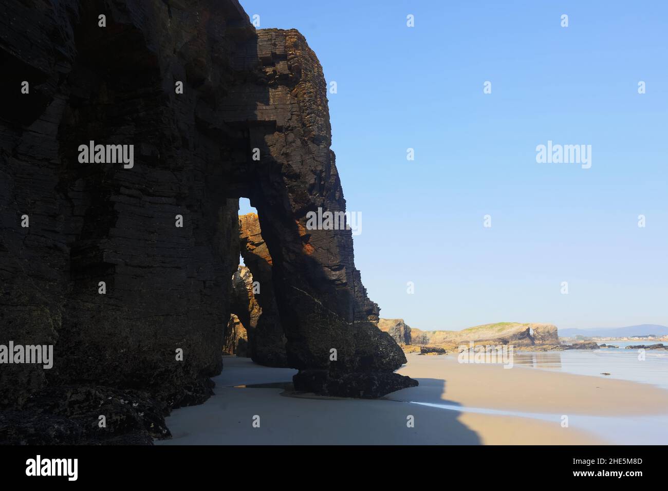 Natural arches at sand beach Stock Photo - Alamy
