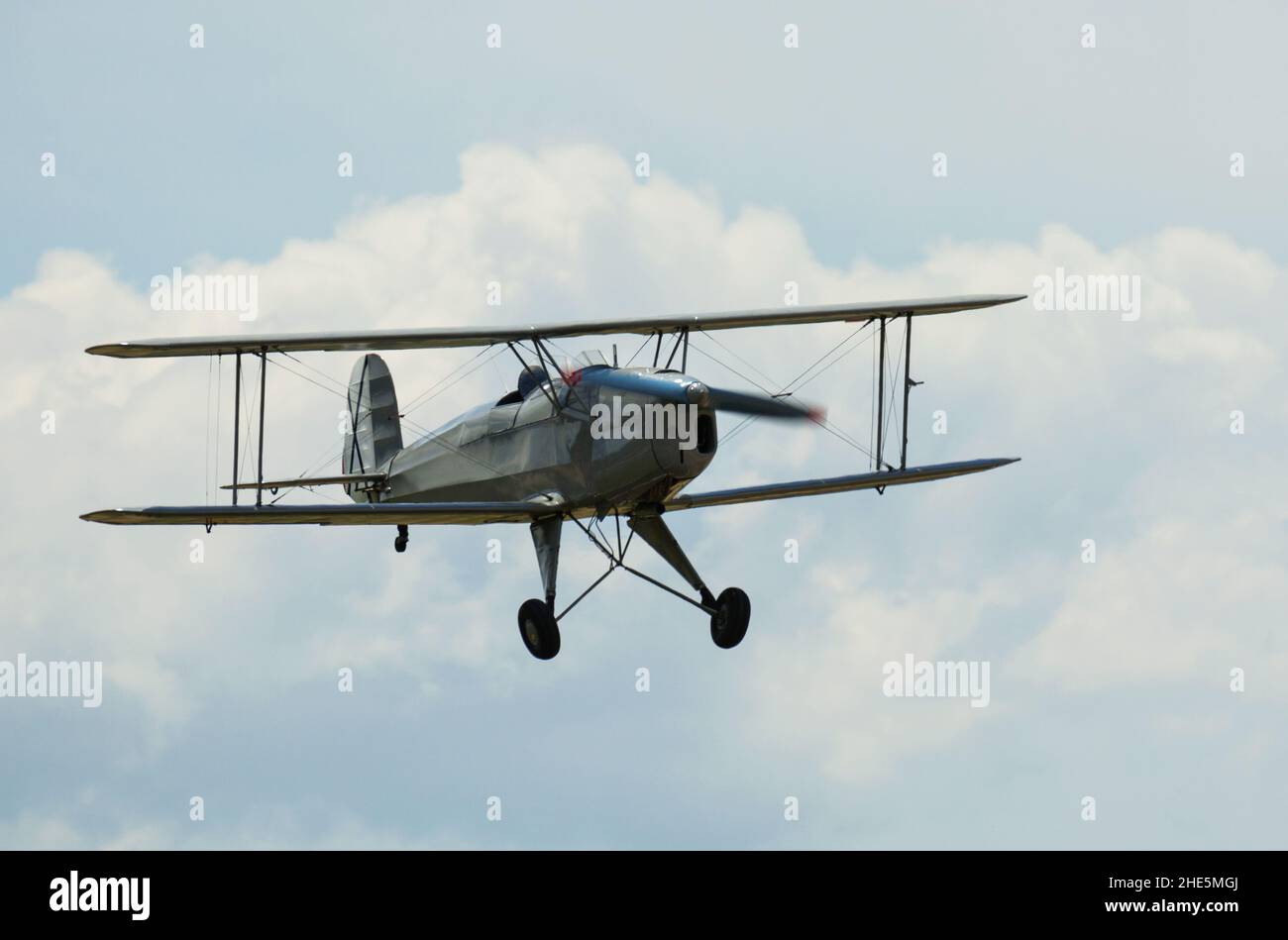 Biplane flying in sky Stock Photo - Alamy