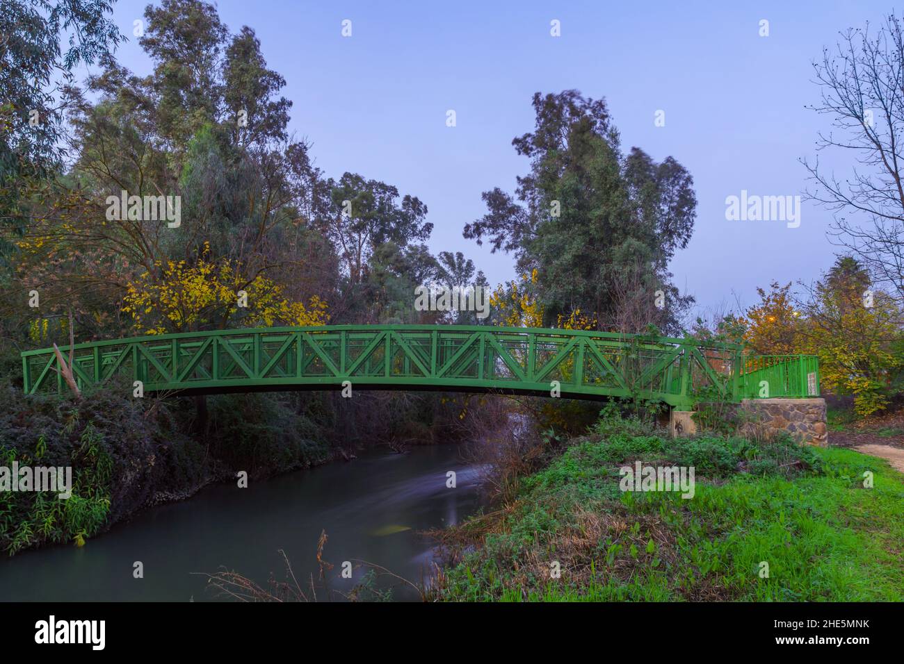 Sunset view of a footbridge at the origin point of the Jordan river ...