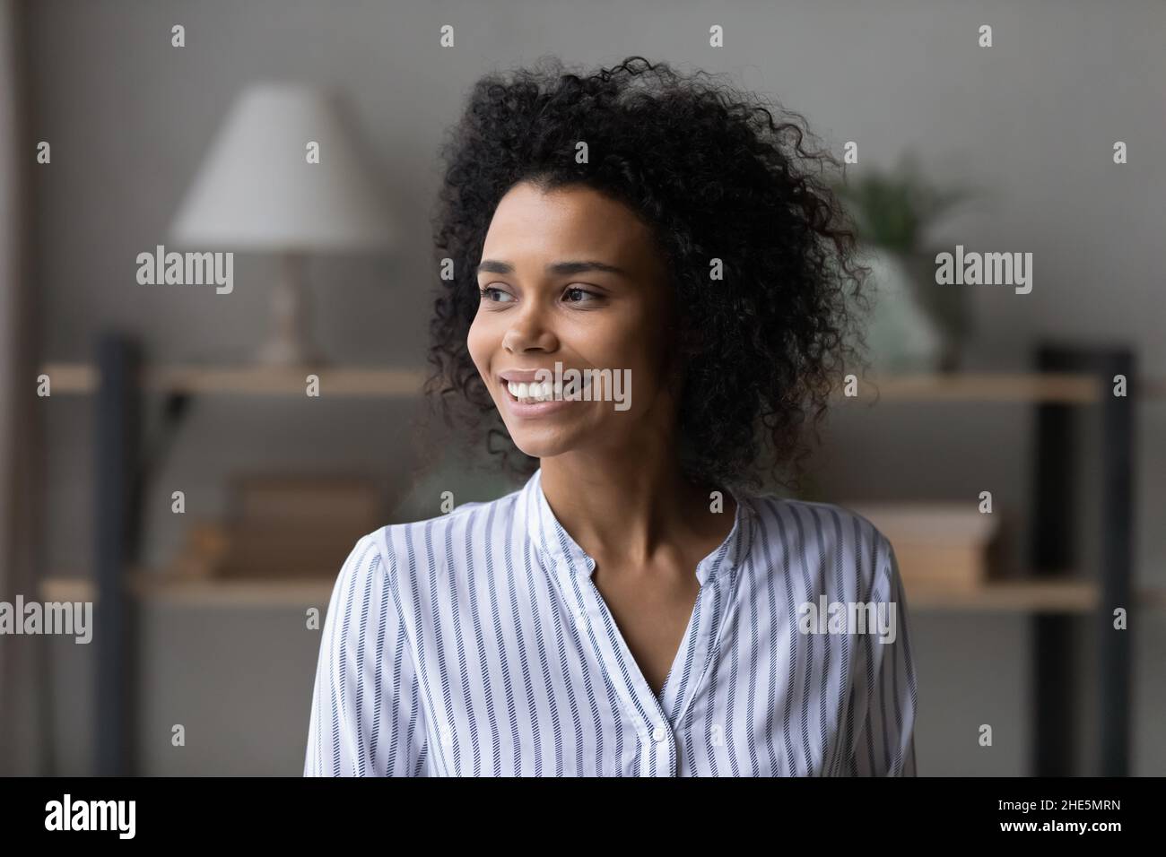 Happy dreamy beautiful african woman looking in distance Stock Photo ...