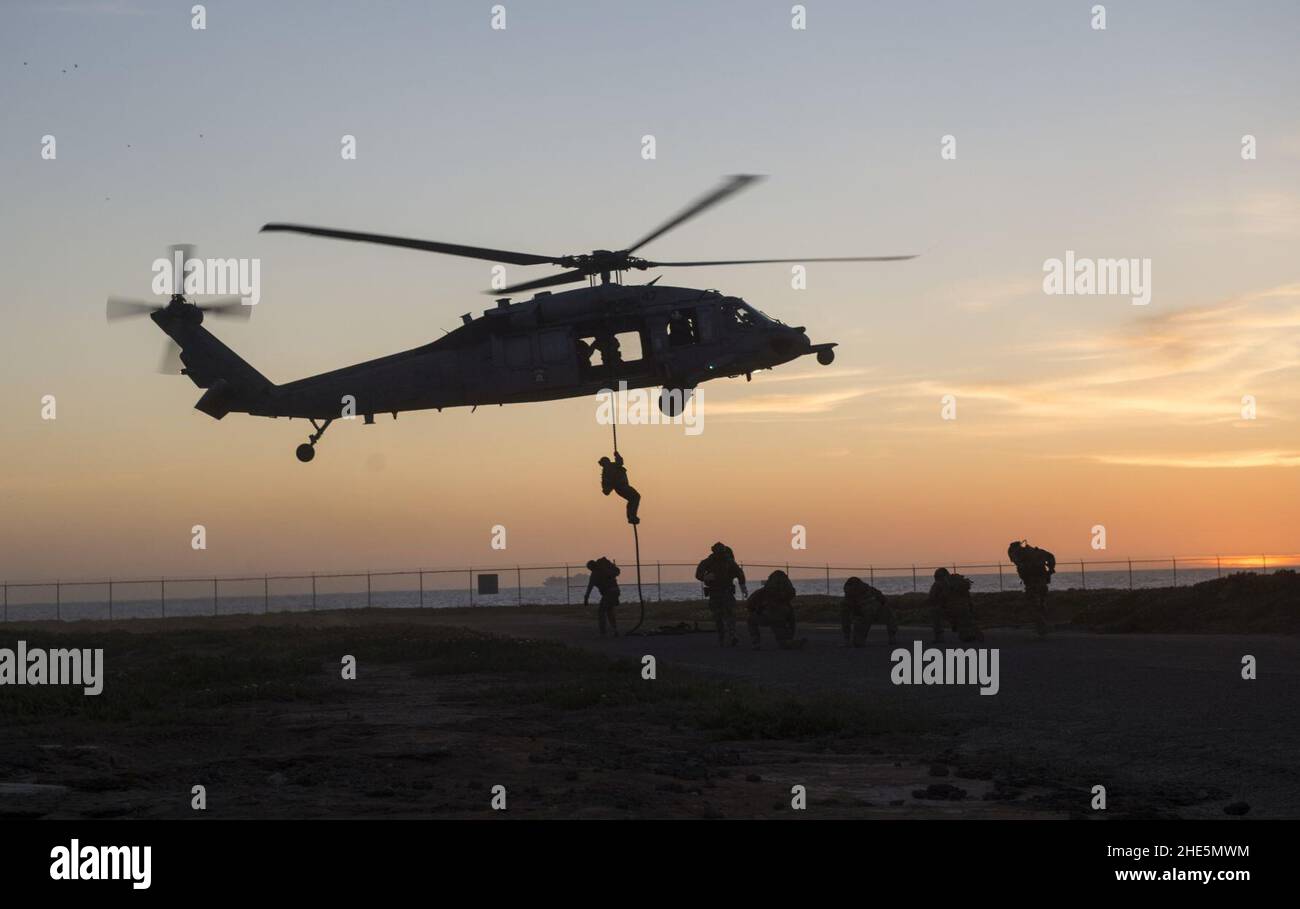 Sailors fast-rope out of an MH-60S Seahawk during a helicopter rope ...