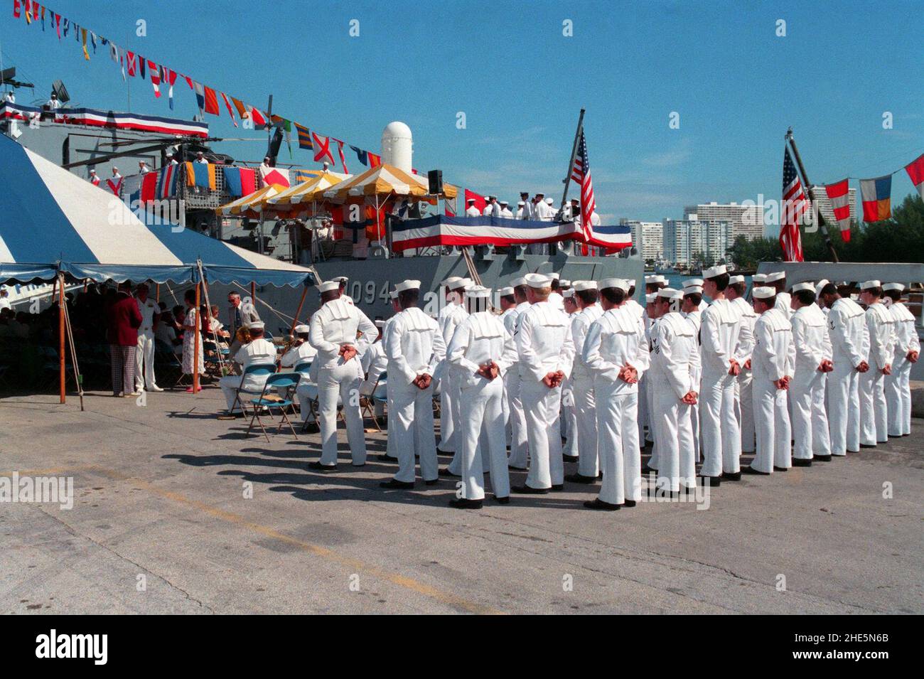 Sailors from USS Pharris (FF-1094) standing at parade rest during ...