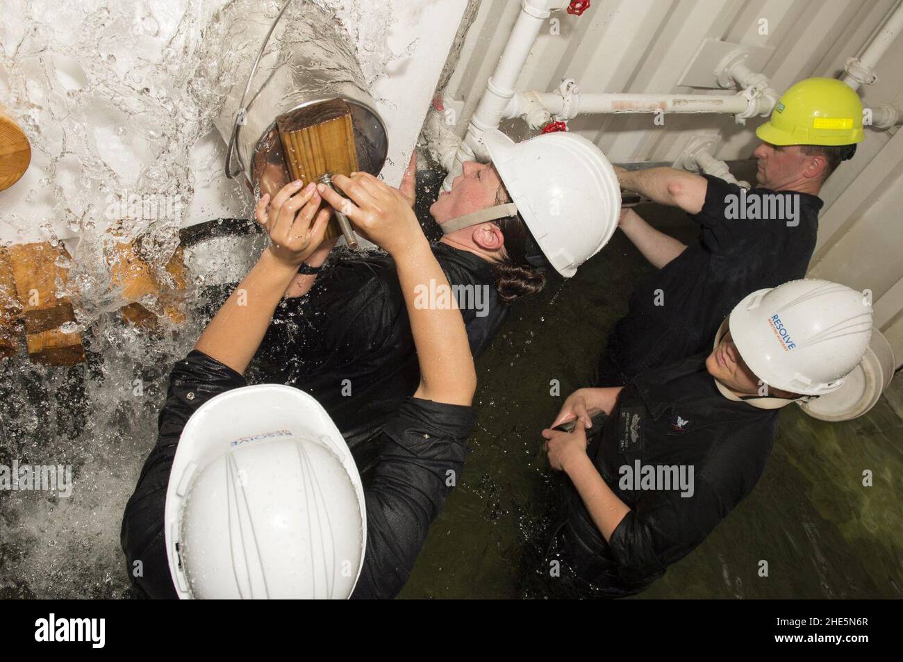 Sailors from USS Bainbridge attempt to stop a flood using multiple ...
