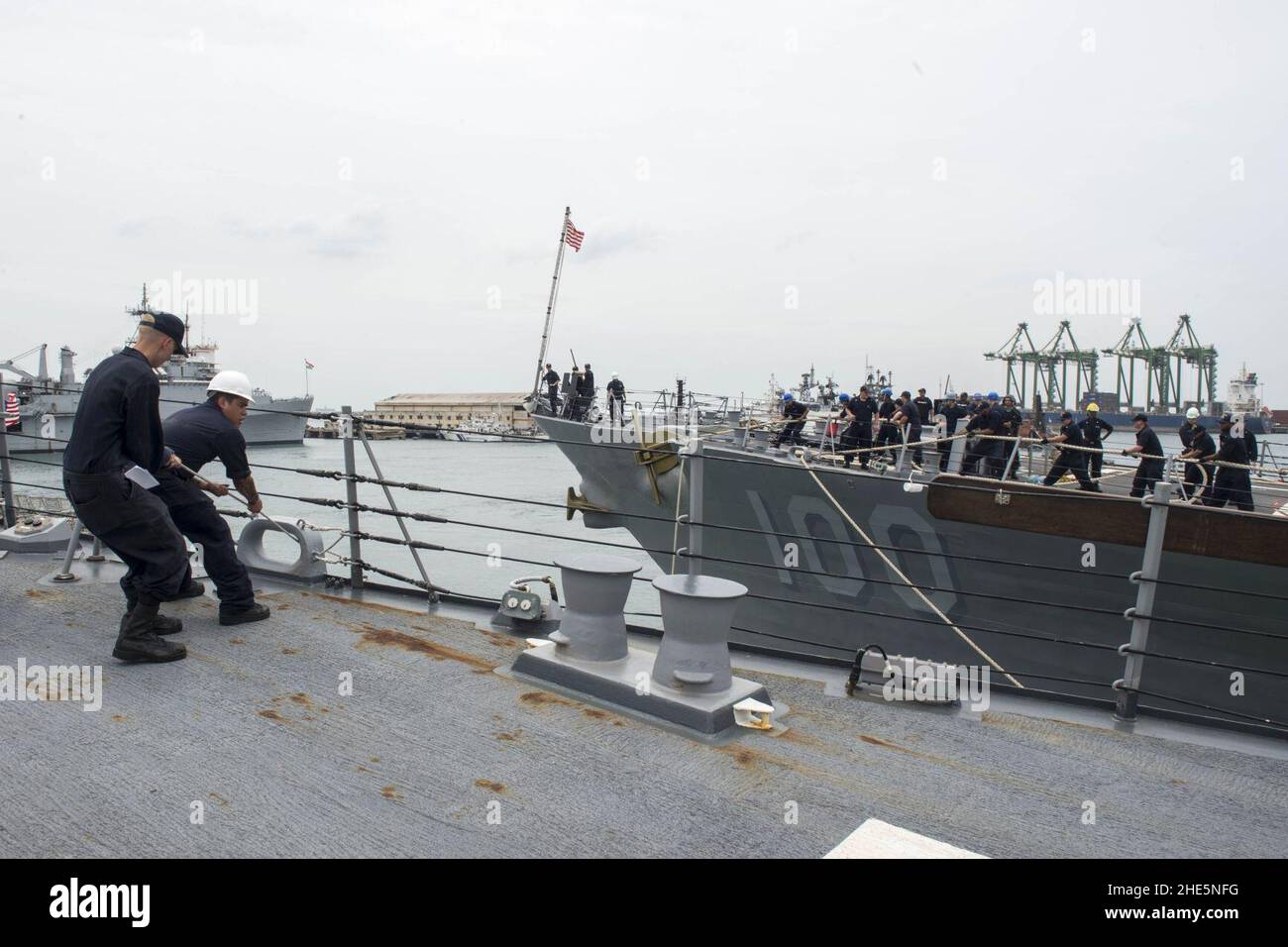 Sailors heave line as the Arleigh Burke-class guided-missile destroyers ...