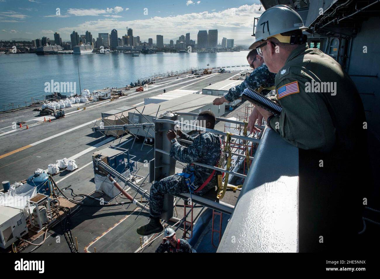 Sailors install an antenna for the SRA-62 combat system on the island ...