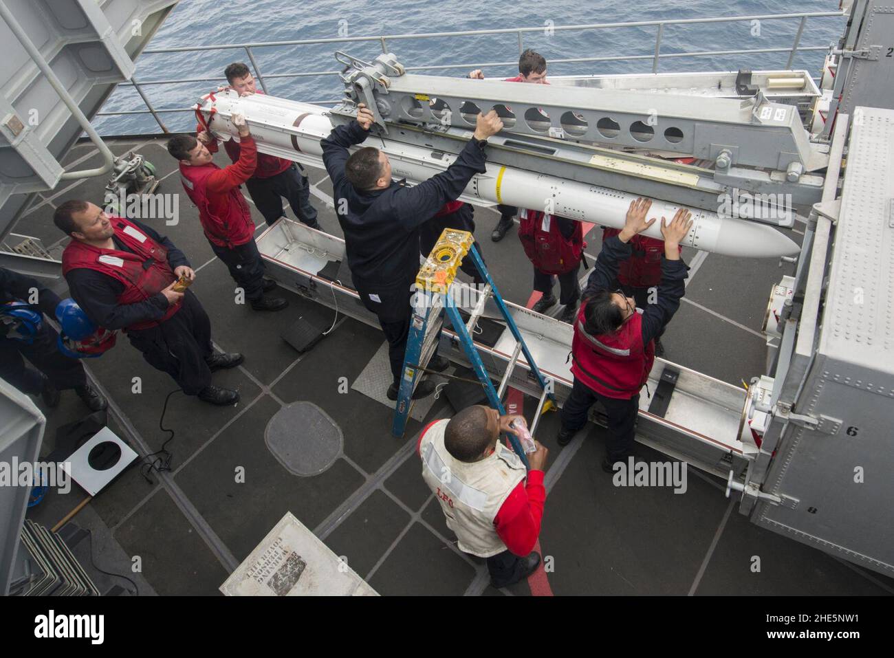 Sailors load a missile into a NATO Sea Sparrow Surface Missile System ...