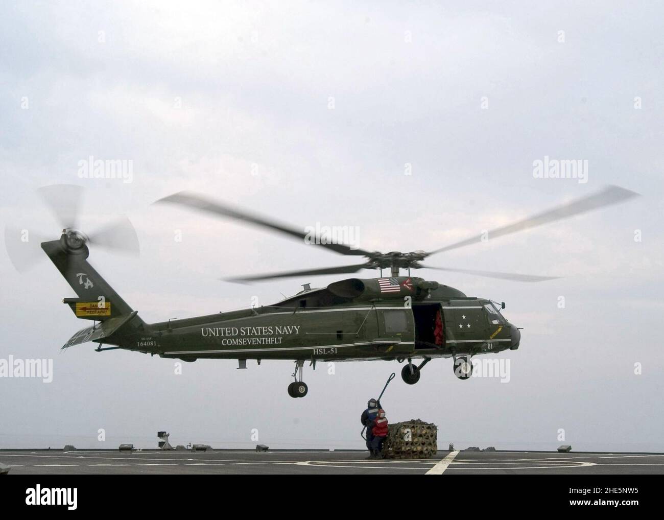 Sailors load helicopter during resupply Stock Photo - Alamy