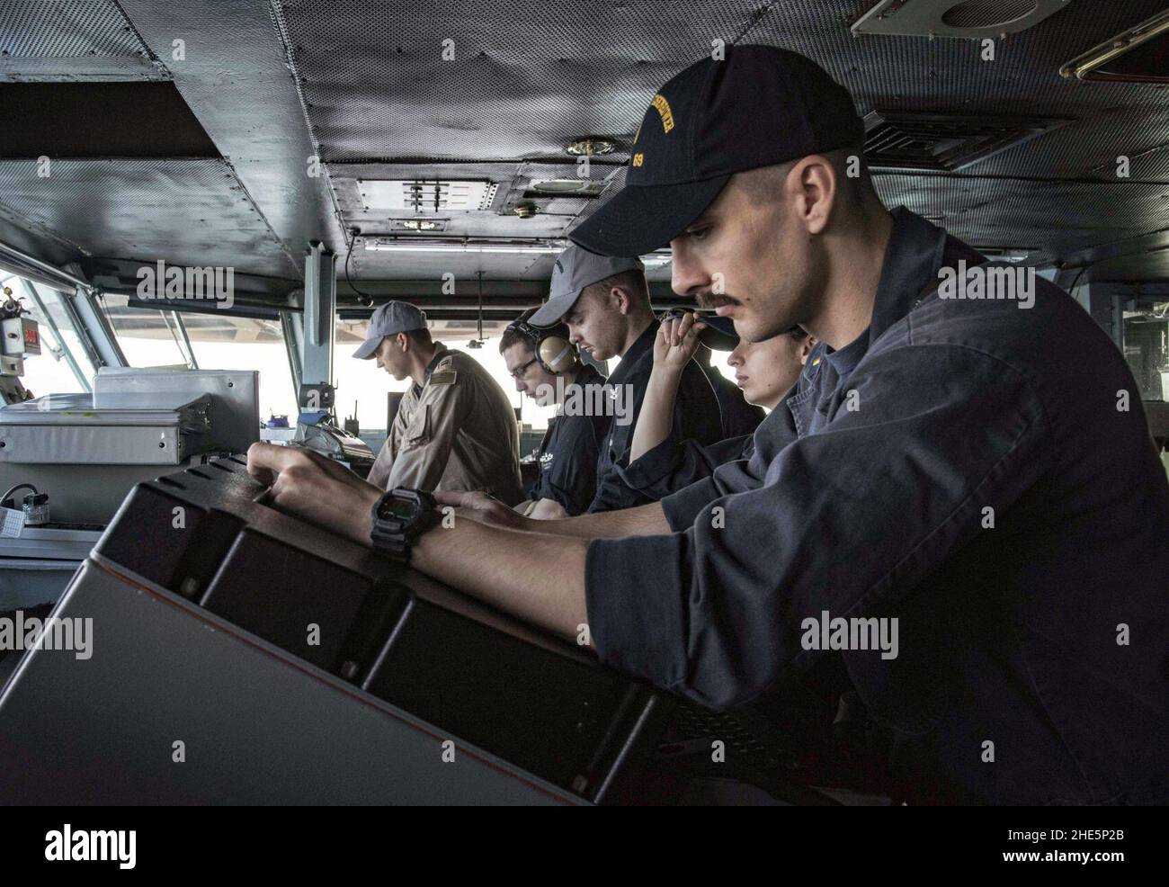 Sailors man watches on the navigation bridge of USS Dwight D ...
