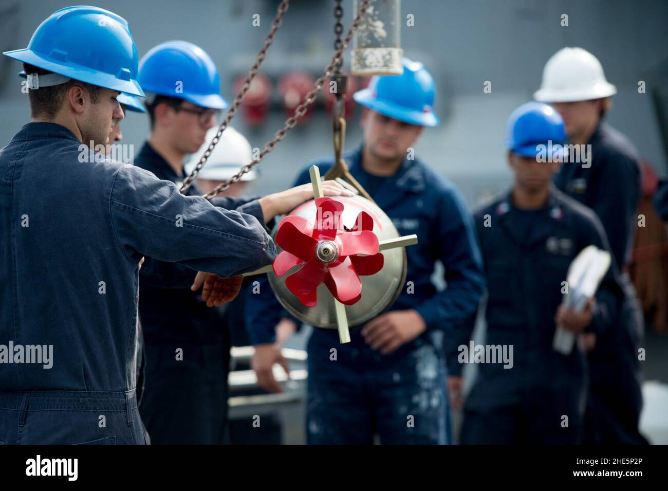 Sailors move an MK 46 MOD 5A torpedo on the aft missile deck ...