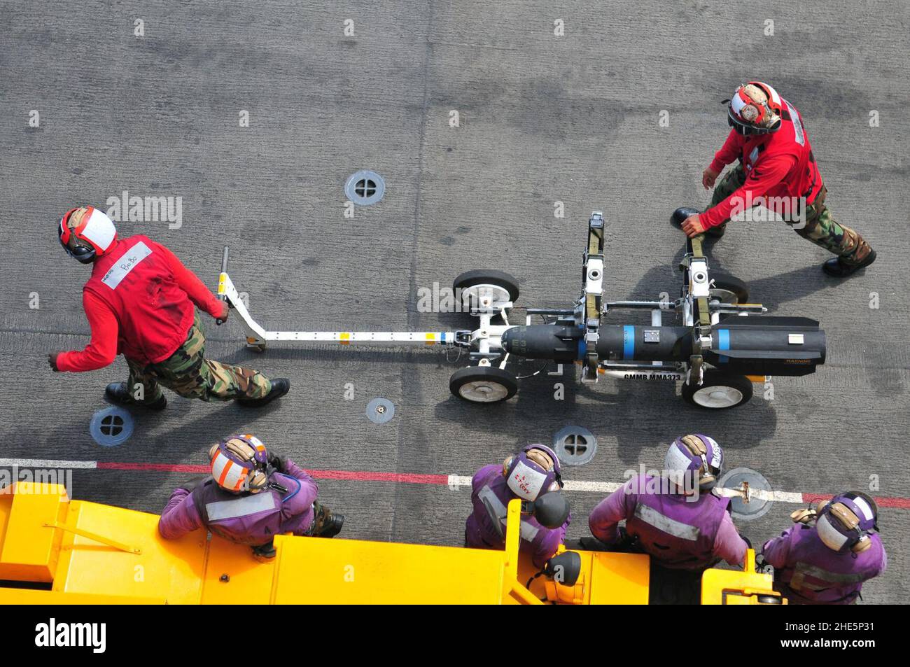 Sailors move a Hellfire Captive Air Training Missile (CATM-114K) across ...