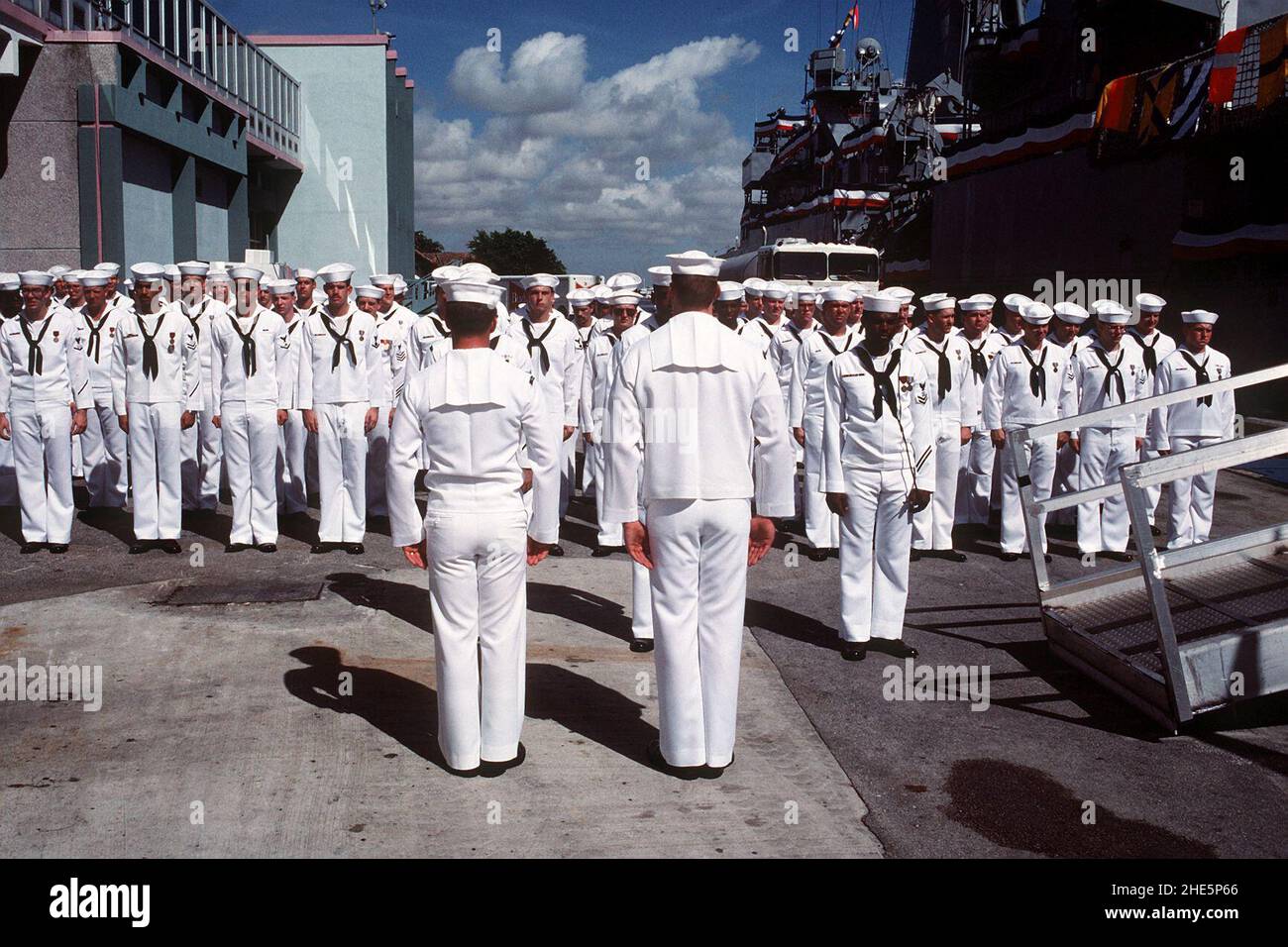 Sailors of USS Pharris (FF-1094) standing at attention during change of ...