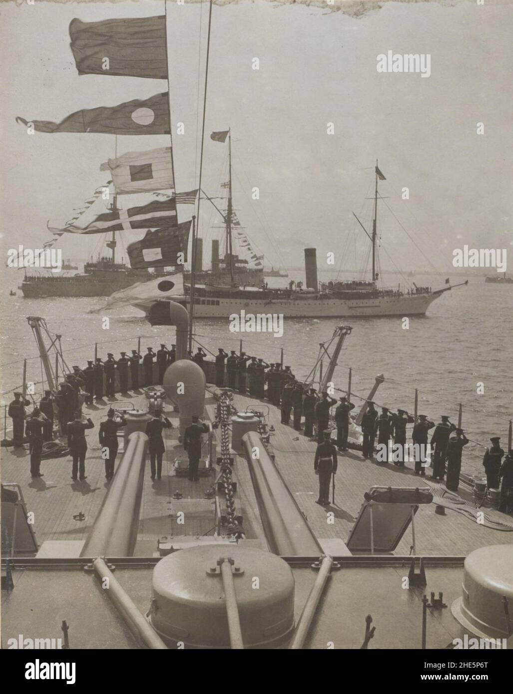 Sailors on ship deck salute at ship passing by Stock Photo - Alamy