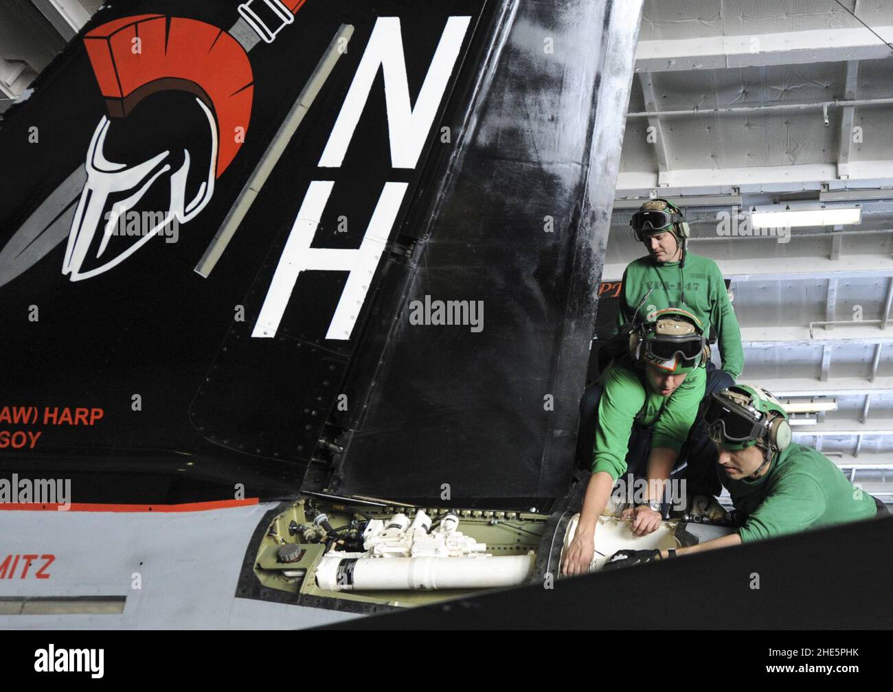 Sailors perform tail wing maintenance on F A-18E at sea. (8813982054 ...