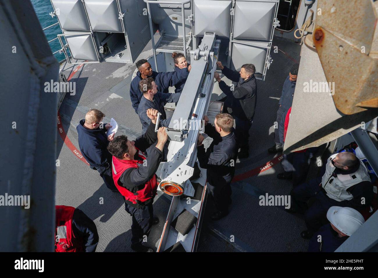 Sailors position a RIM-7 Sea Sparrow missile into a NATO Sea Sparrow ...