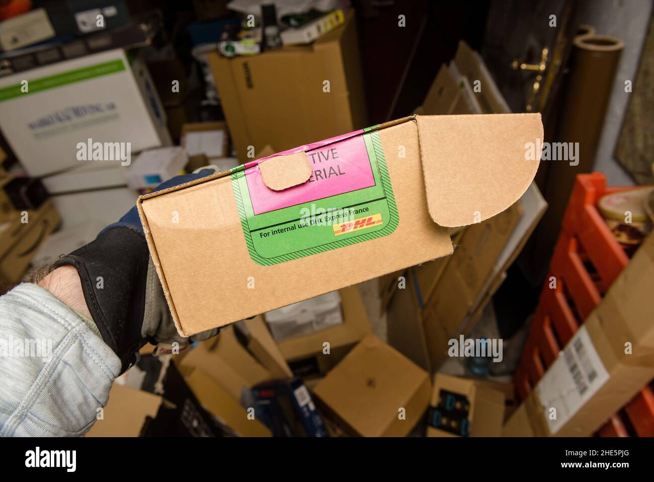 Frankfurt, Germany - Dec 10, 2021: Hand holding in warehouse DHL open ...