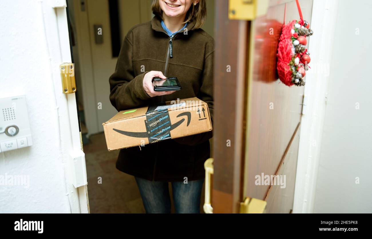 Paris, France - Jan 27, 2016: Door open with Smiling UPS female worker ...