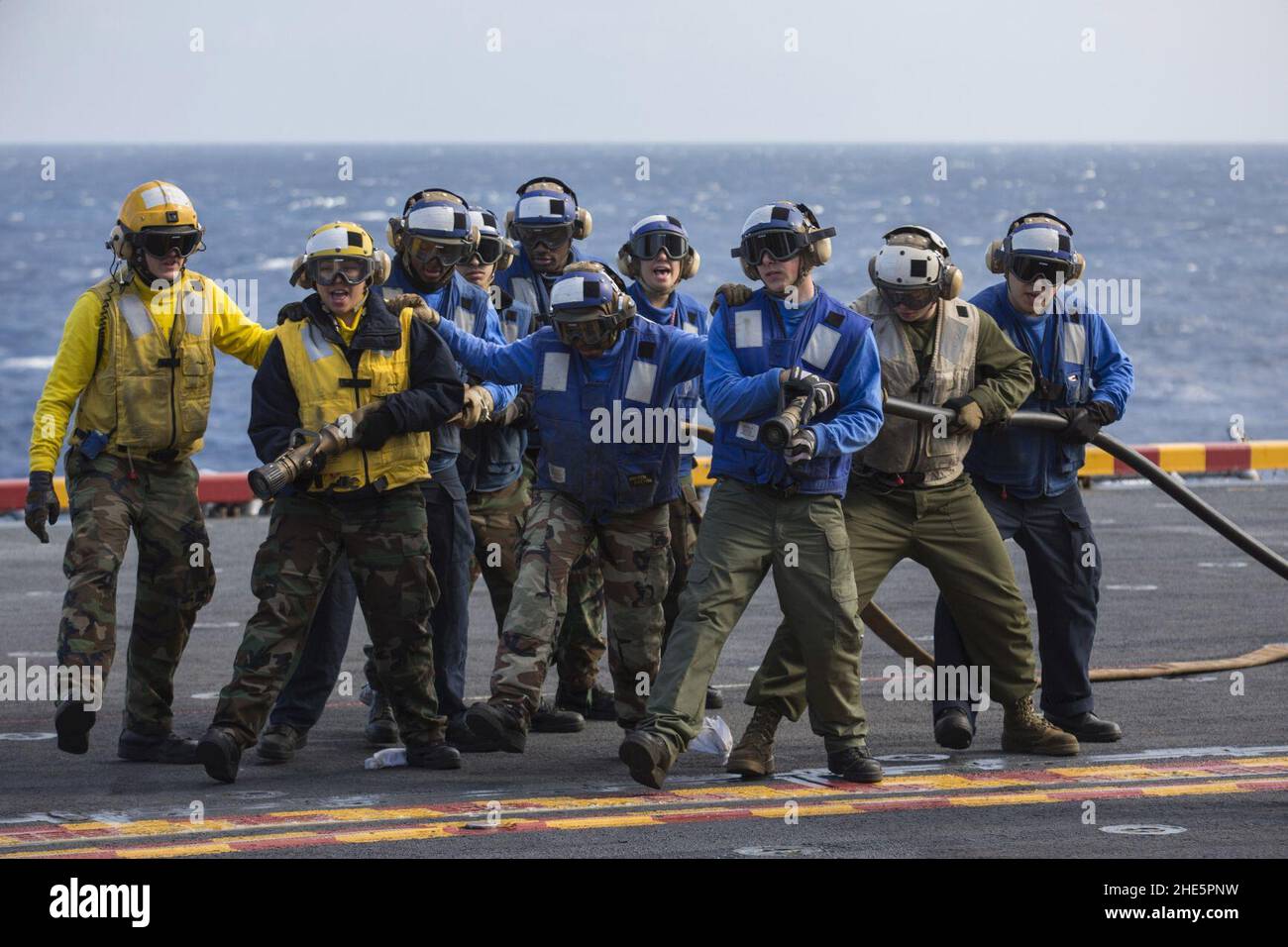 Sailors practice firefighting at sea. (8572073052 Stock Photo - Alamy