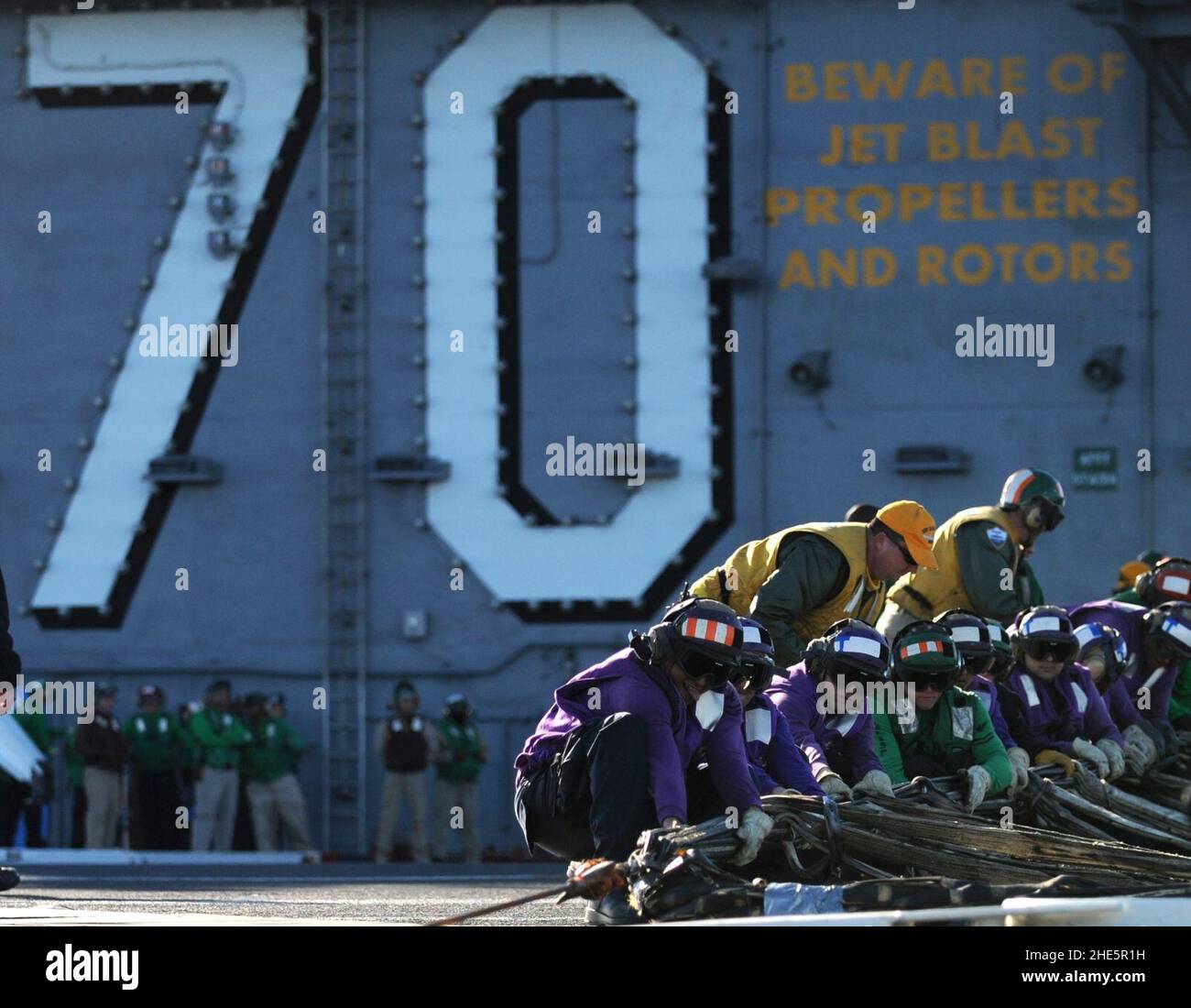 Sailors pull a barricade aboard USS Carl Vinson. (8471158610 Stock ...