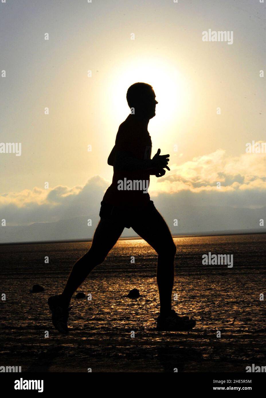 Sailors run through desert Stock Photo - Alamy