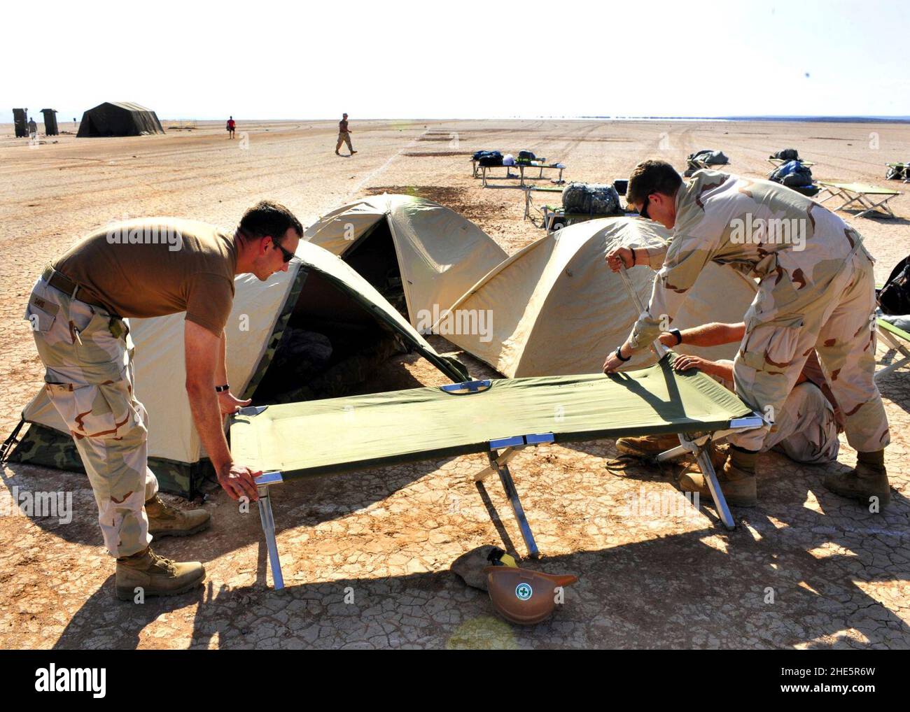 Sailors run through desert Stock Photo - Alamy