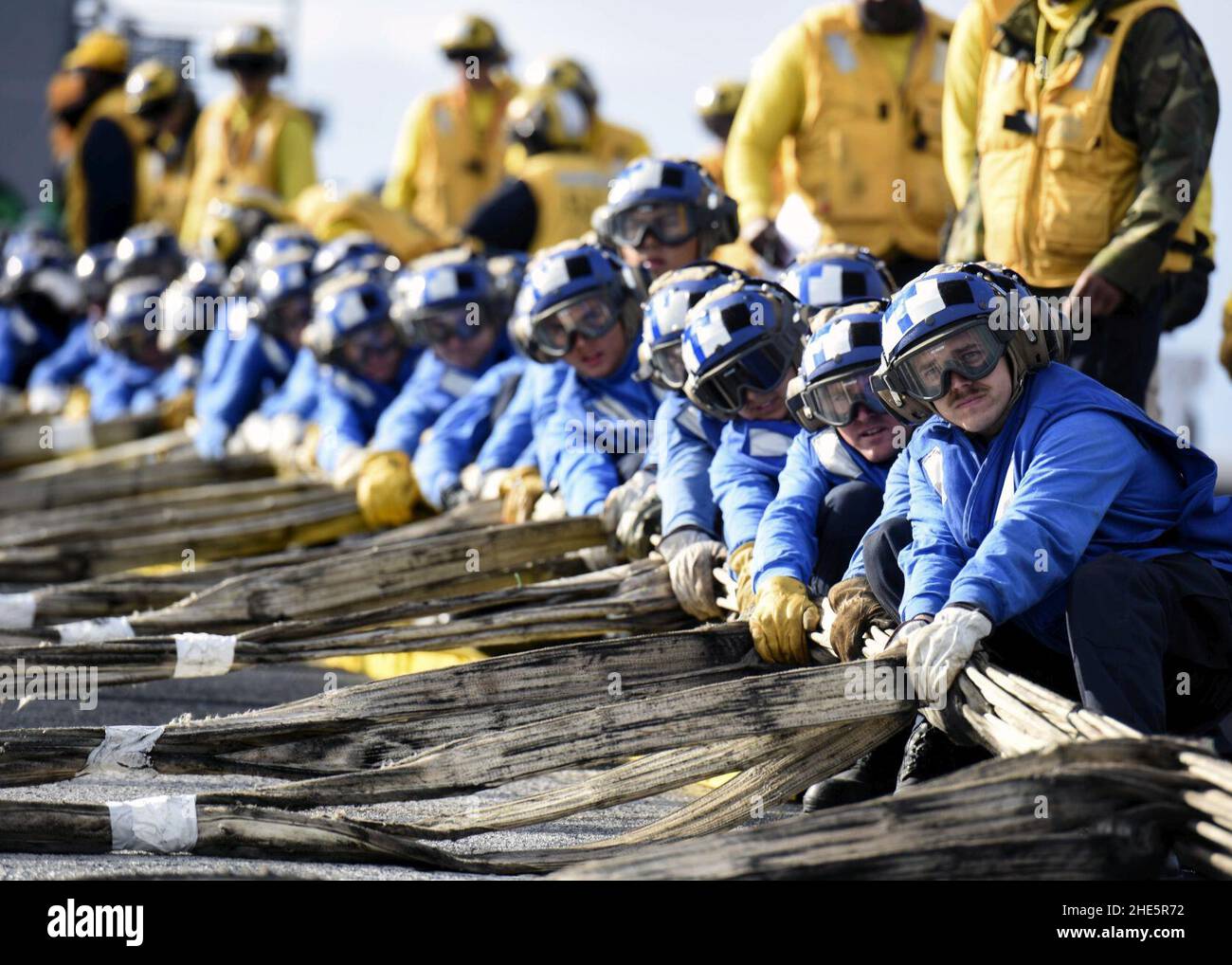 Sailors rig the ship's baracade during a drill on USS Nimitz's flight ...