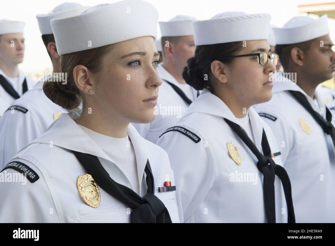 Sailors stand in formation for a dress white uniform inspection ...