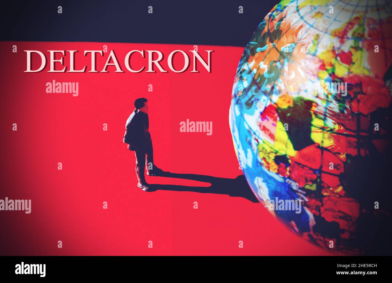 Miniature Man observing the planet earth in a red background Stock ...