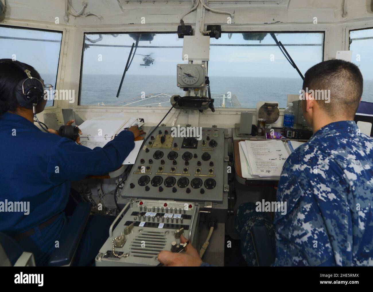 Sailors watch a H-60 as it approaches USS Carter Hall. (8498331000 ...