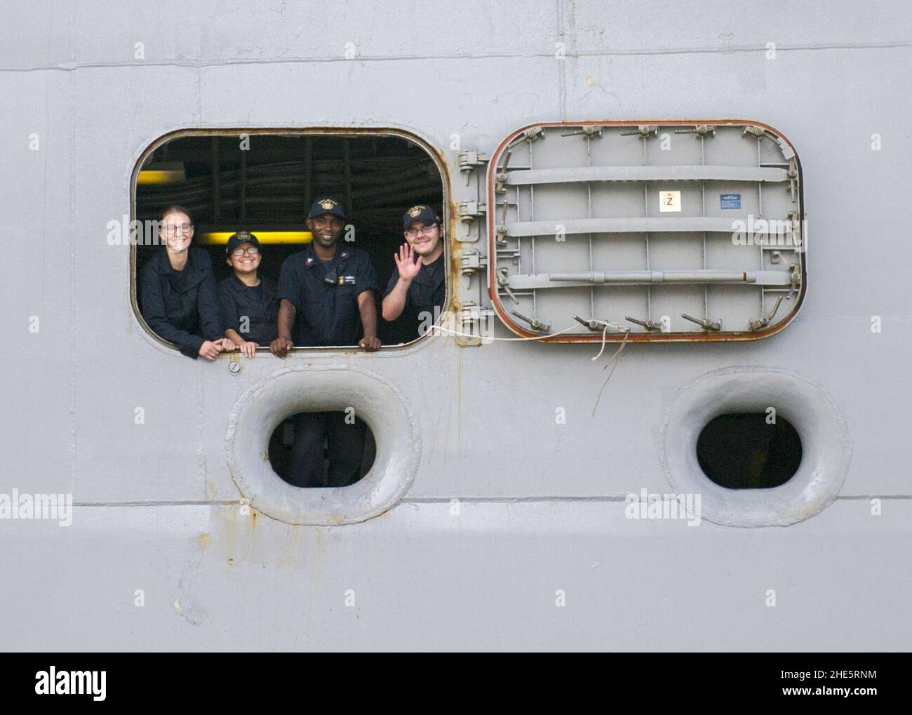 Sailors wave goodbye as the ship departs Naval Station Norfolk ...