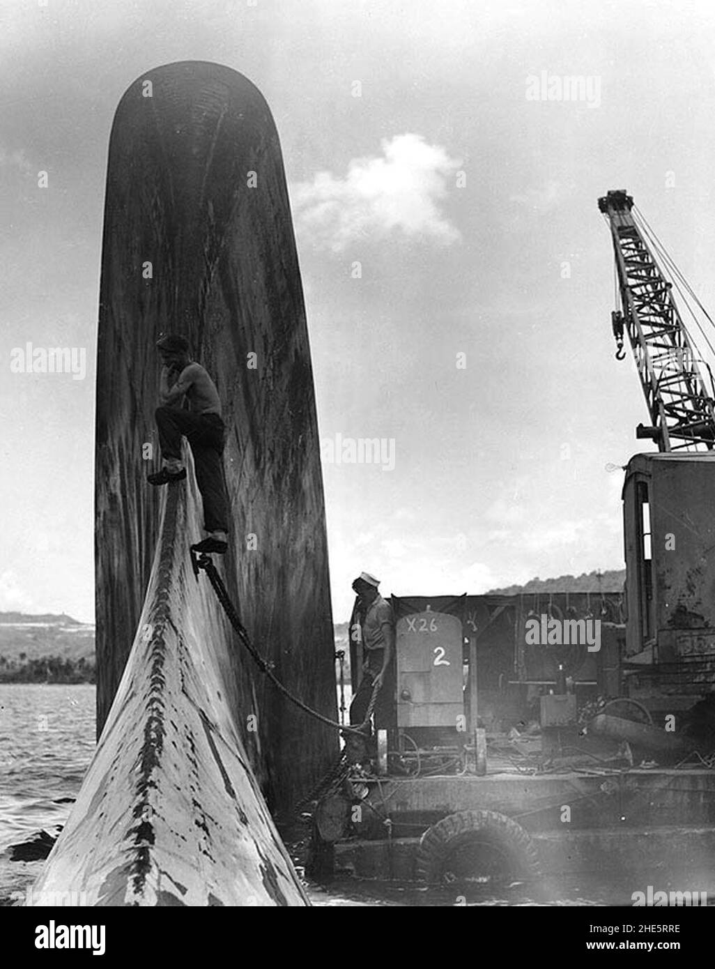 Sailors work on bow of USS Pittsburgh (CA-72) at Guam in 1945 Stock ...