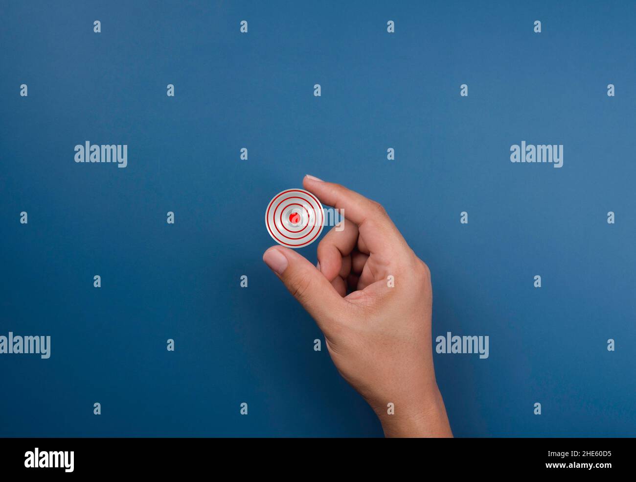 Modern small red target icon symbol in hand on blue. Small business ...