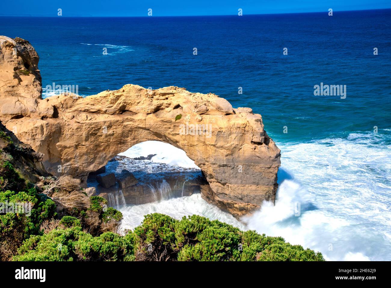 Aerial view of the Arch along the Great Ocean Road with limestone ...