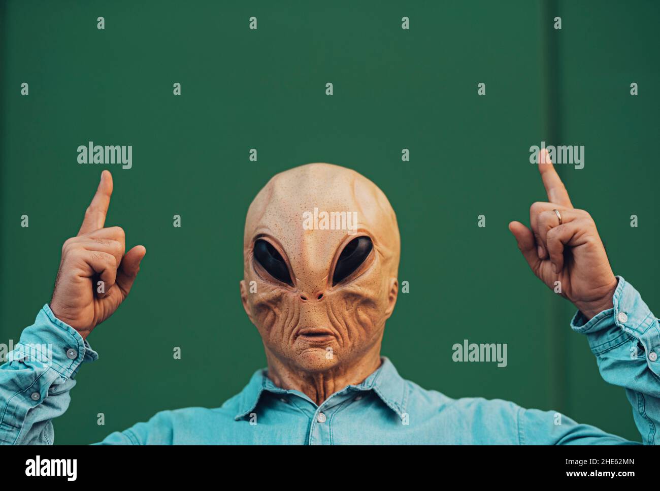 Portrait of ufo alien extraterrestrial mask with denim casual clothing ...