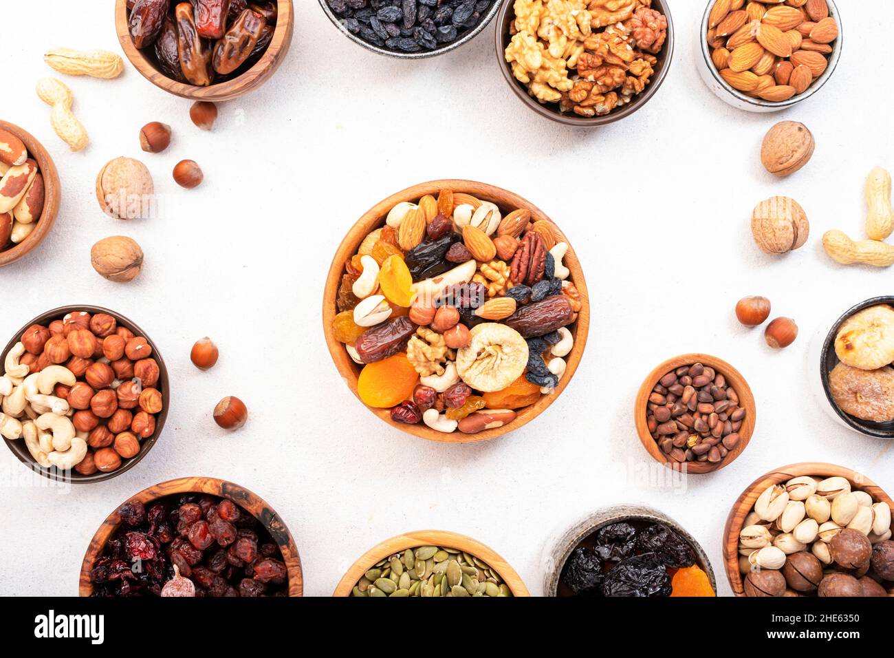 Dried fruits nuts in bowls set. Dry apricots, figs, raisins, walnuts, almonds and other. Healthy ...
