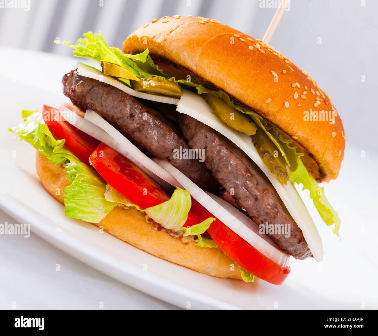 Tasty double-decker grilled burger with beef, tomato, cheese Stock ...