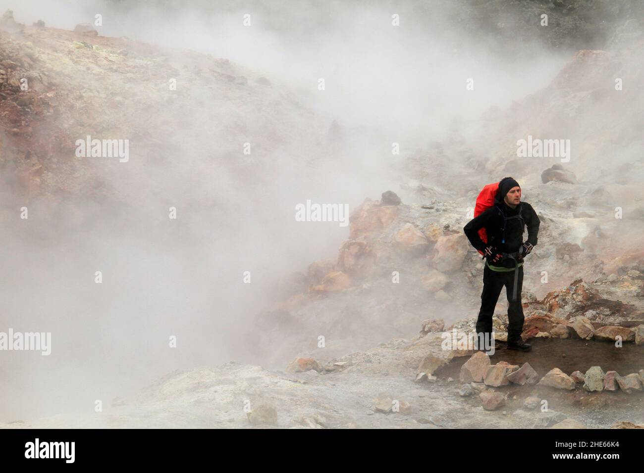 Hiker in Iceland in clouds of volcanic smoke Stock Photo - Alamy
