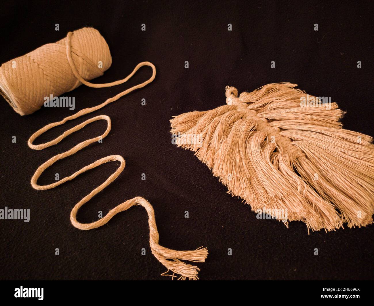 beautiful Macramé or macrame handicraft and reel of macrame cord in ...