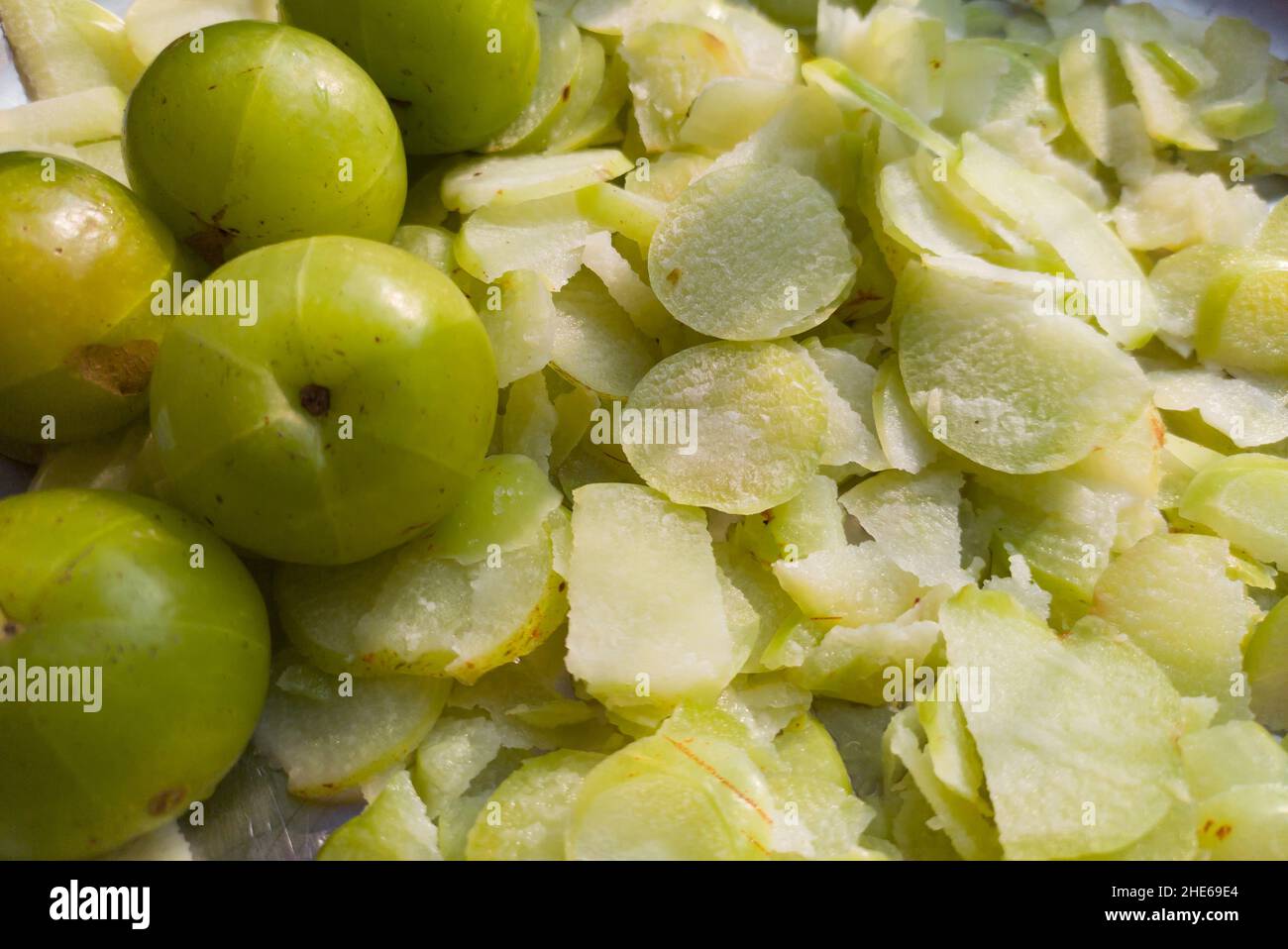 indian gooseberry or amla kept in sunlight for drying. chopped fresh ...