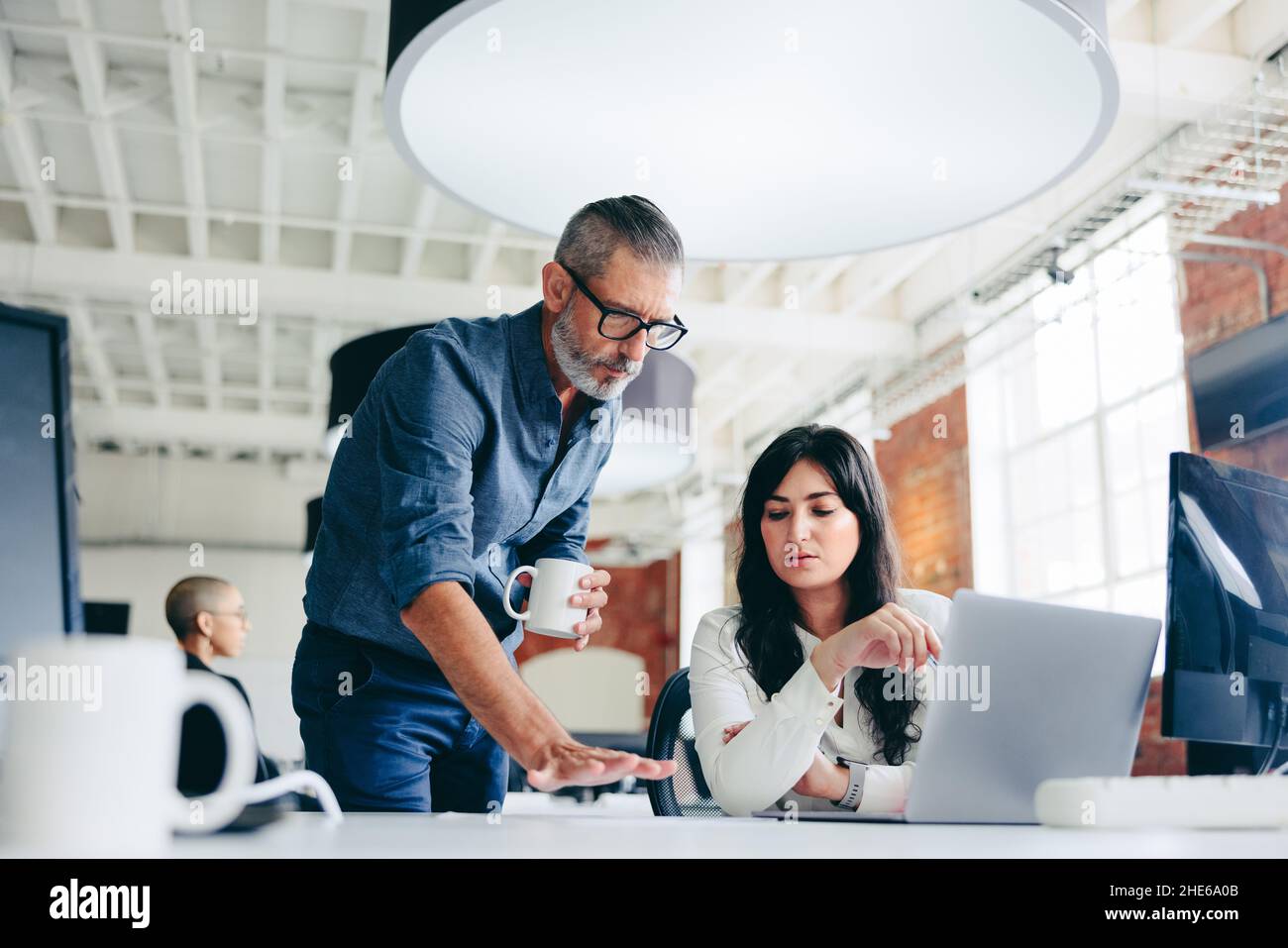 Teamwork in the modern office. Mature businessman having a discussion ...