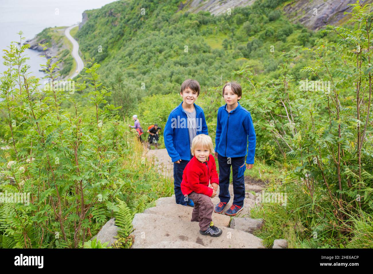 Children, toddler, brothers and father, climbing the stairs to ...