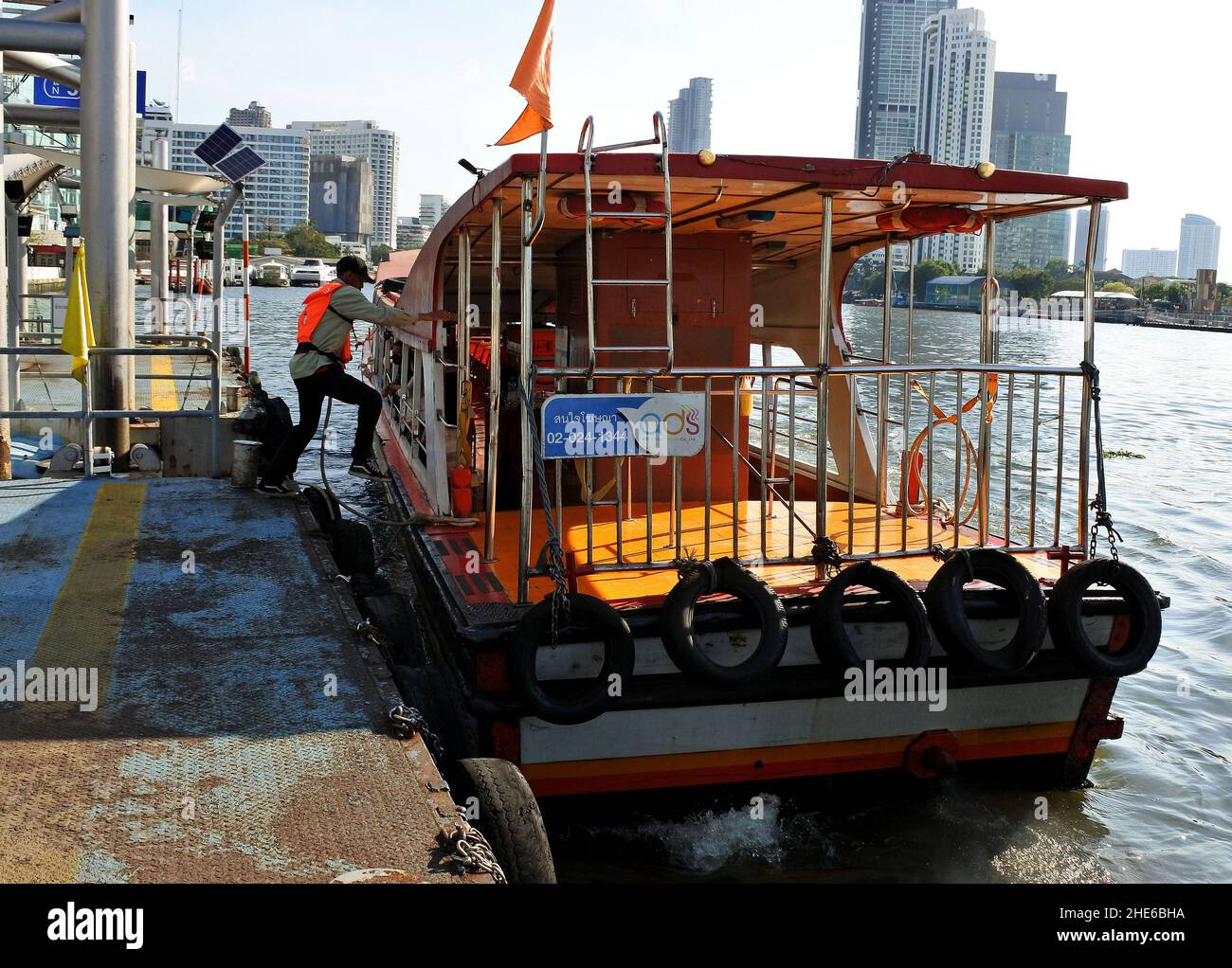 Bangkok, Thailand. 08th Jan, 2022. An express boat rope handler jumps ...