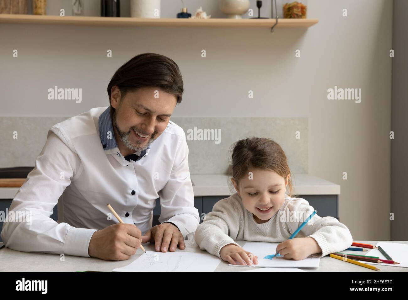 Happy father and little preschool daughter kid using colored pencils ...