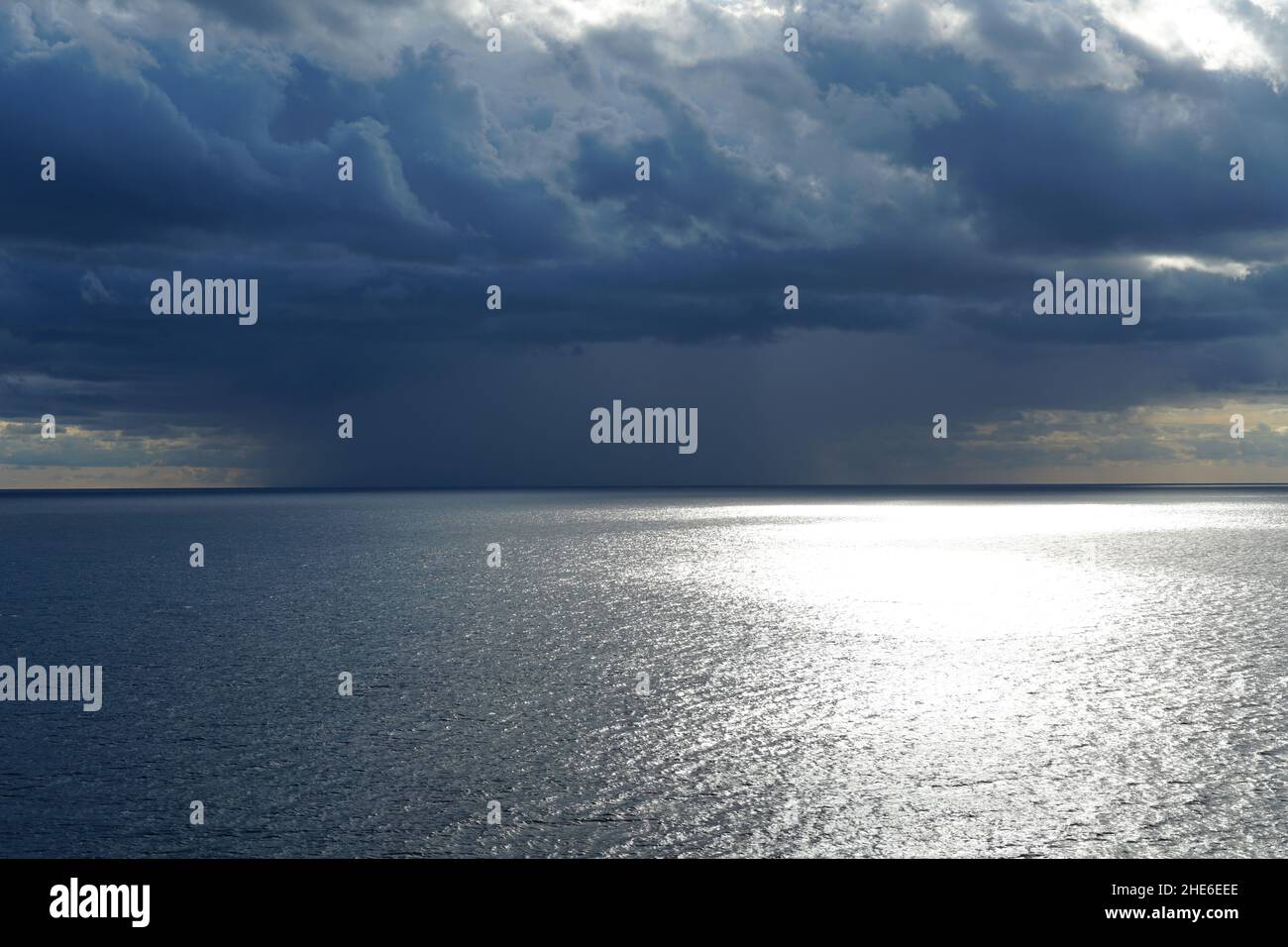 Heavy dark blue rain clouds on horizon of Pacific ocean Stock Photo - Alamy