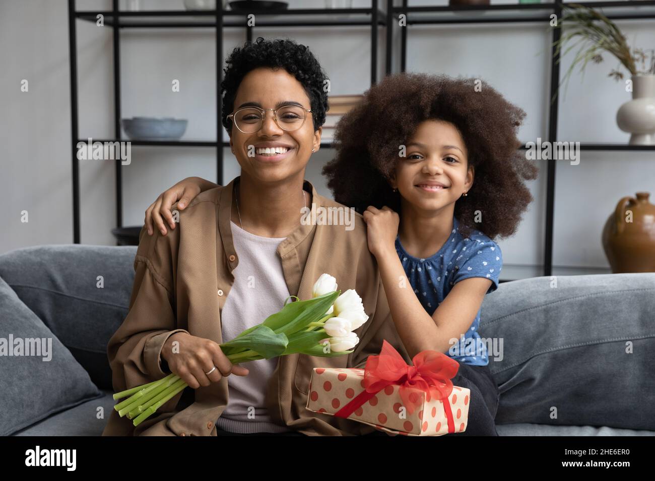 Young woman hugging gift box hi-res stock photography and images - Alamy