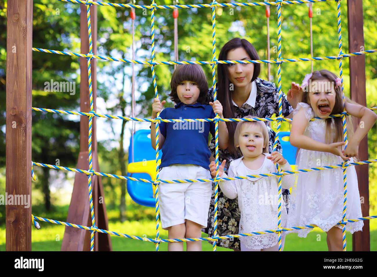 Young large family on a summer morning walk. Beautiful mother with ...